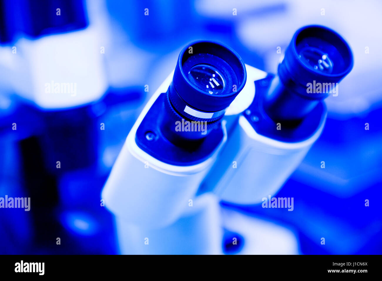 A shot of a microscope in a blue tone (shallow depth of field Stock ...