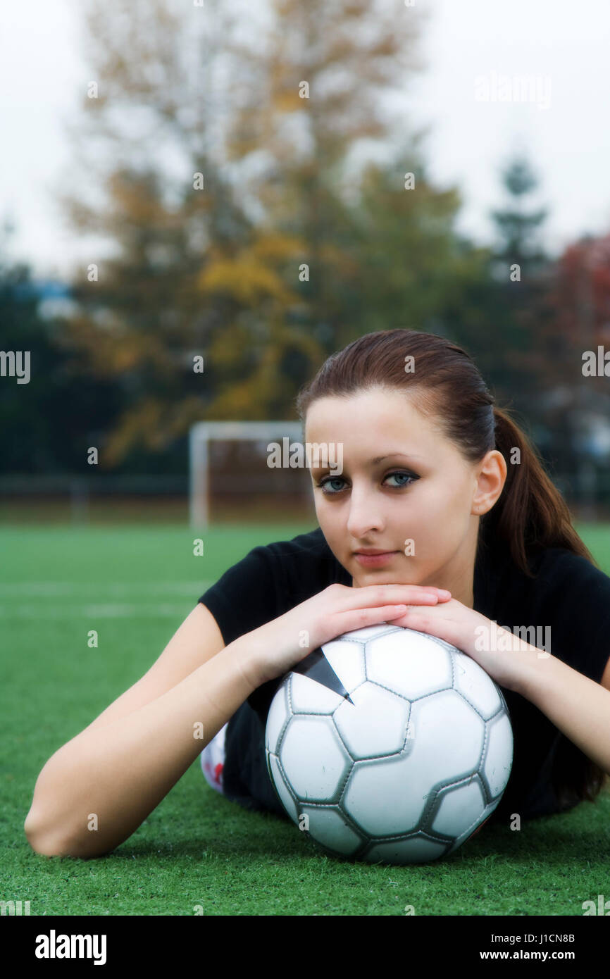 A beautiful soccer player resting on a soccer ball Stock Photo - Alamy