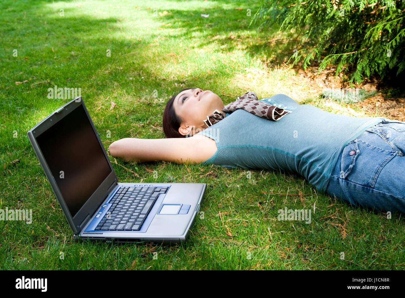 A college student taking a break and relaxing at a park Stock Photo - Alamy