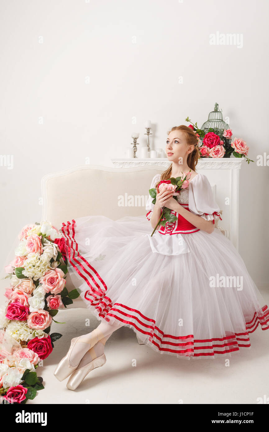 Pretty Ballerina In Stage Costume Holding A Bouquet Of Spring Flowers
