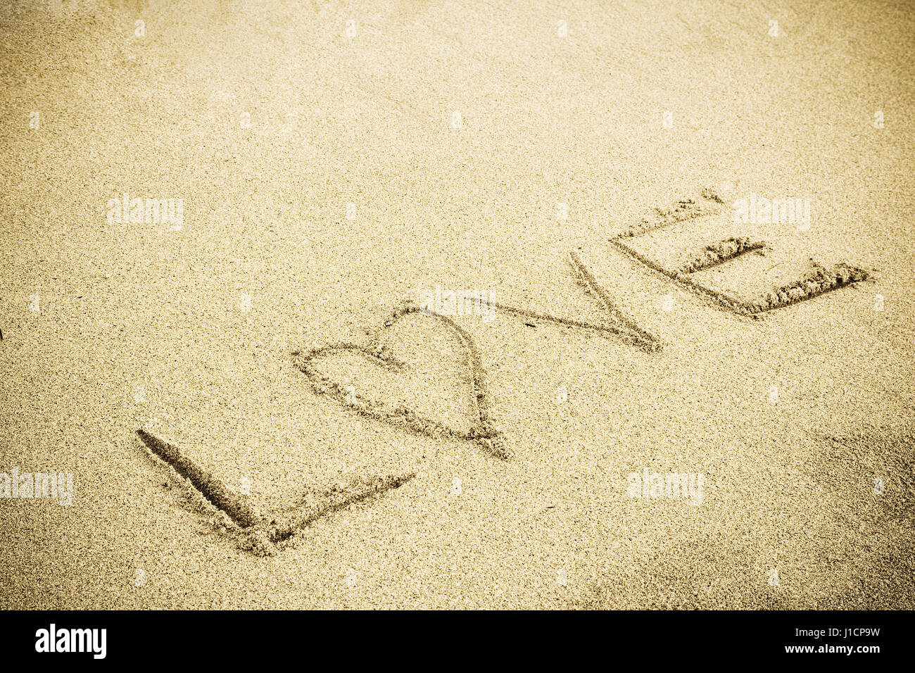 A drawing of letter LOVE on the sandy beach Stock Photo - Alamy