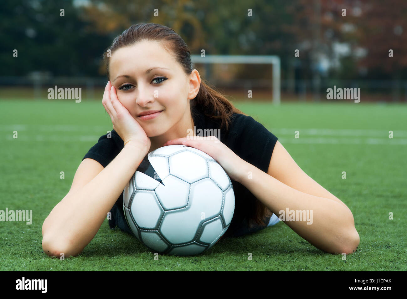 A beautiful soccer player resting on a soccer ball Stock Photo - Alamy