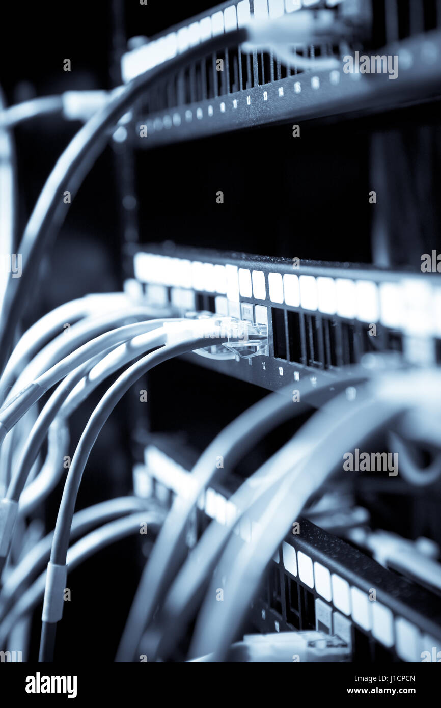 A shot of network cables connected to switches in a data center (in ...