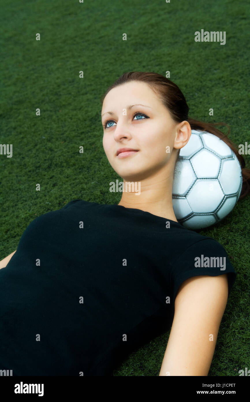 A beautiful soccer player resting on a soccer ball Stock Photo - Alamy