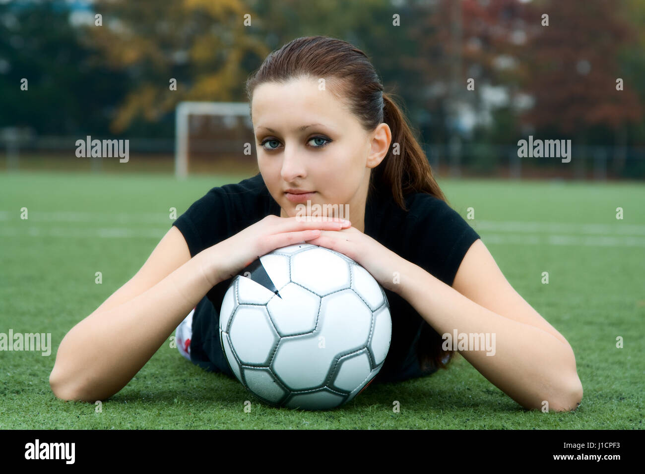 A beautiful soccer player resting on a soccer ball Stock Photo - Alamy