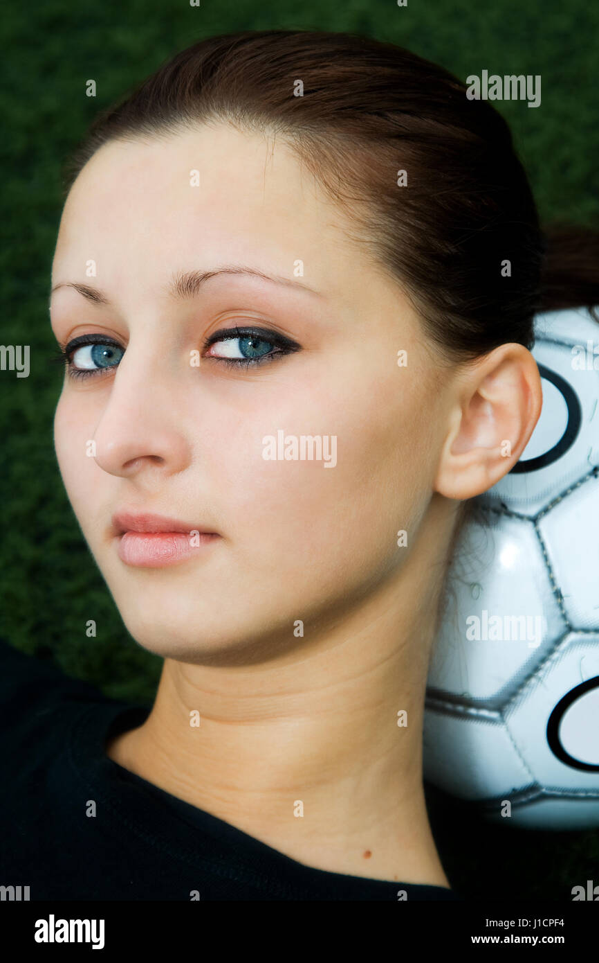 A beautiful soccer player resting on a soccer ball Stock Photo - Alamy