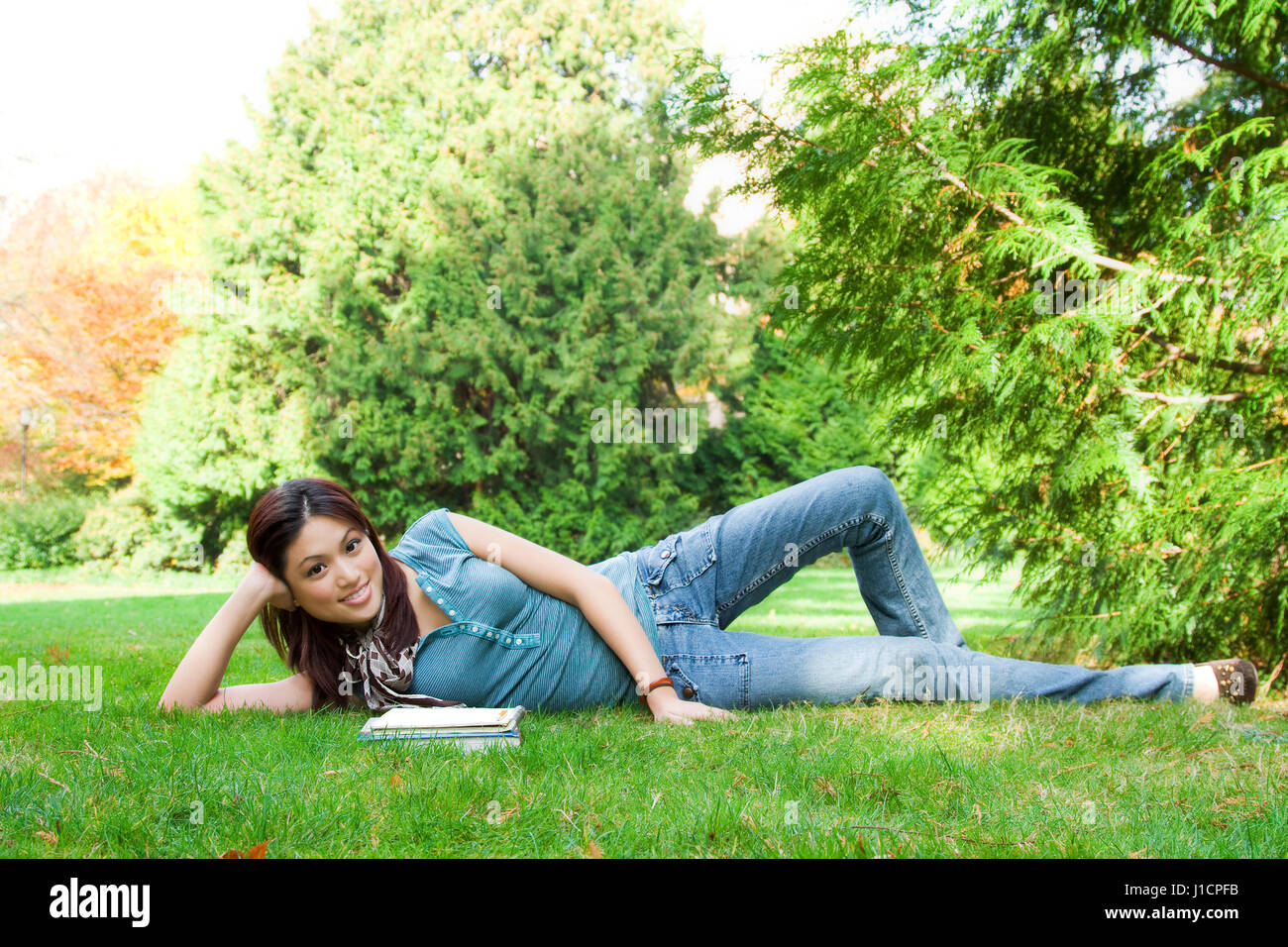 A beautiful college student studying at a park Stock Photo - Alamy
