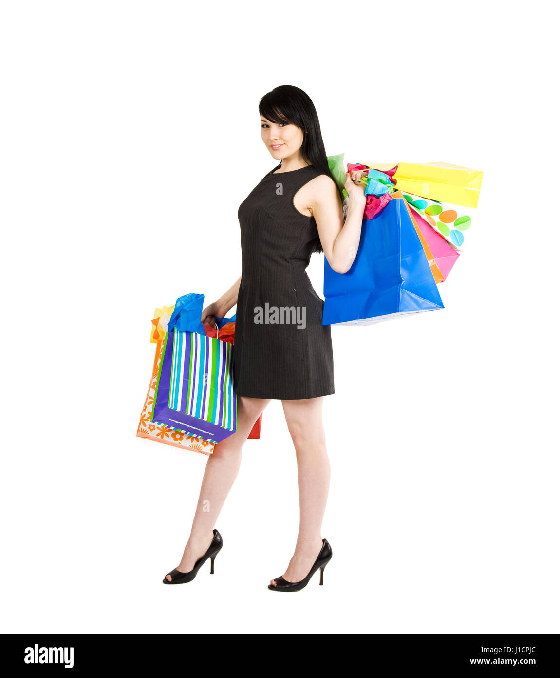 An isolated shot of a beautiful woman carrying shopping bags Stock ...