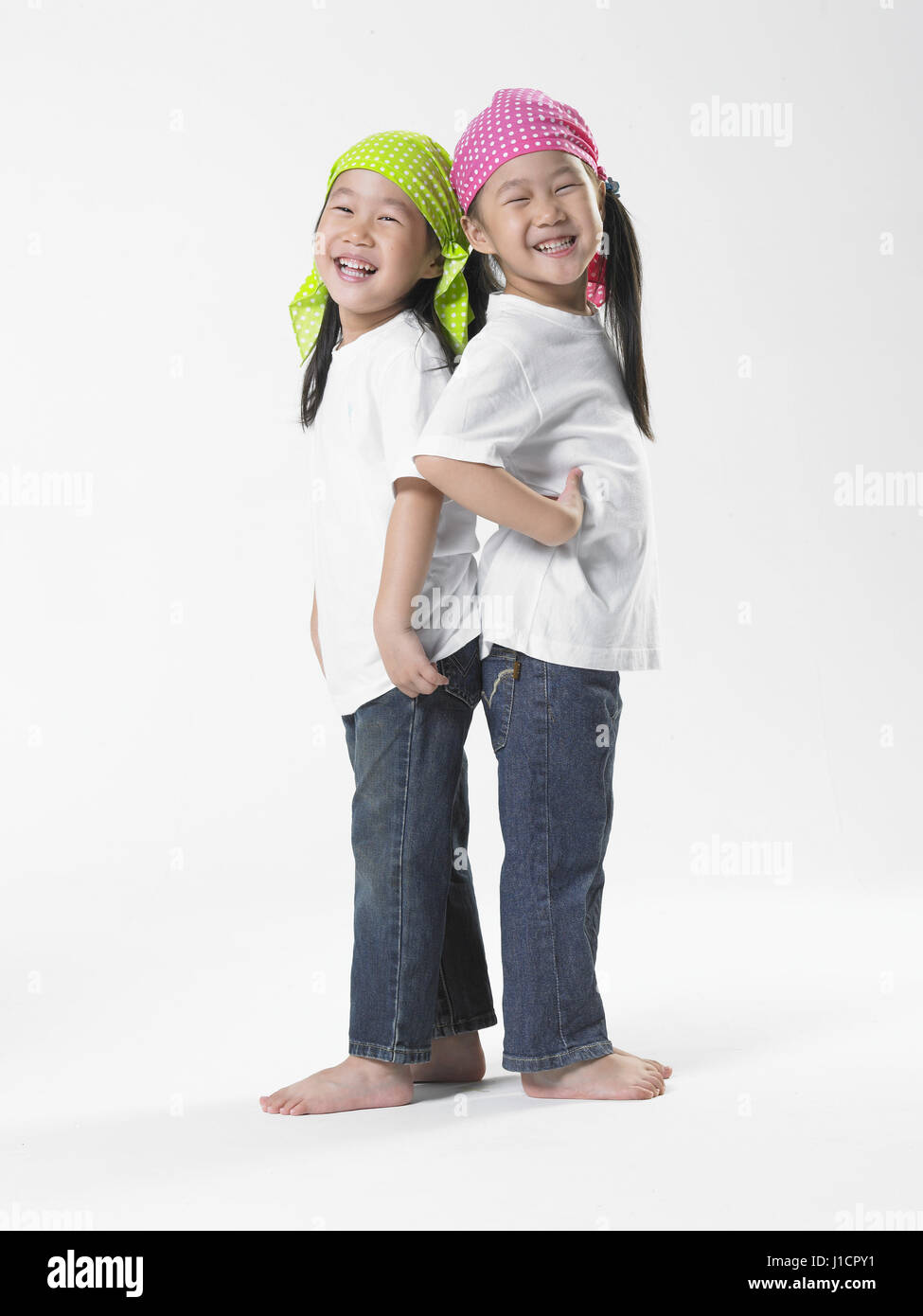 Twins standing back to back hi-res stock photography and images - Alamy