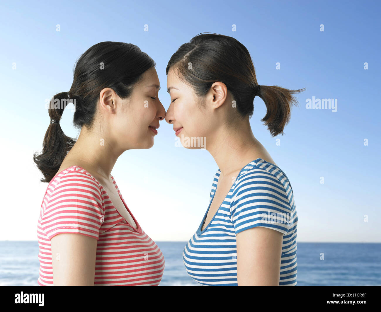 People touching twins women hi-res stock photography and images - Alamy