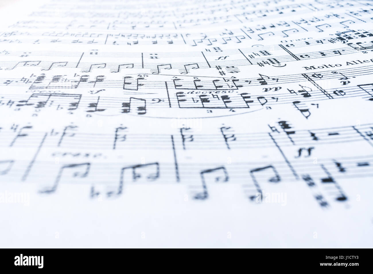 Musical note marks on wavy white sheet of paper. Selective focus Stock ...