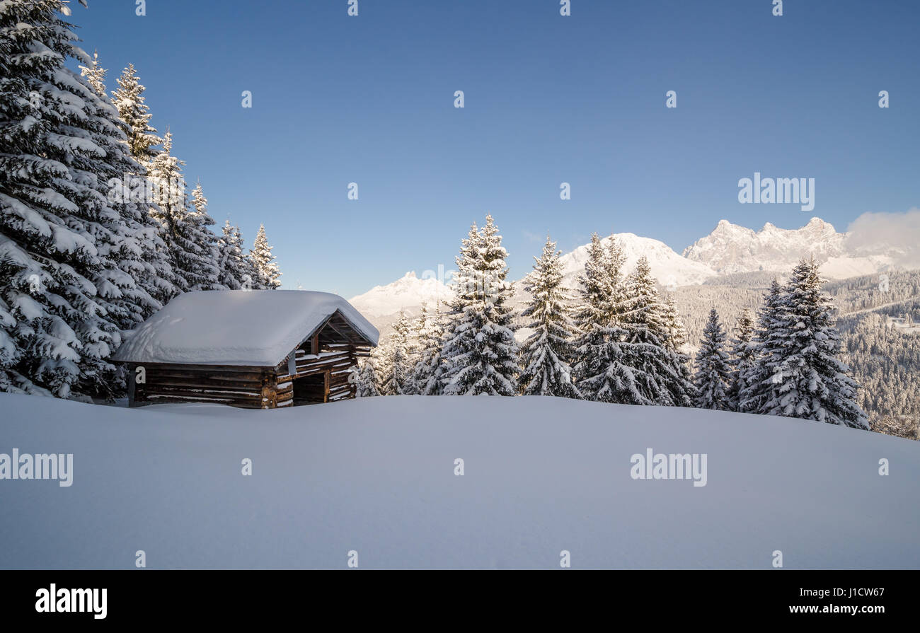 Log cabin in a snow covered landscape in the Austrian Alps Stock Photo ...