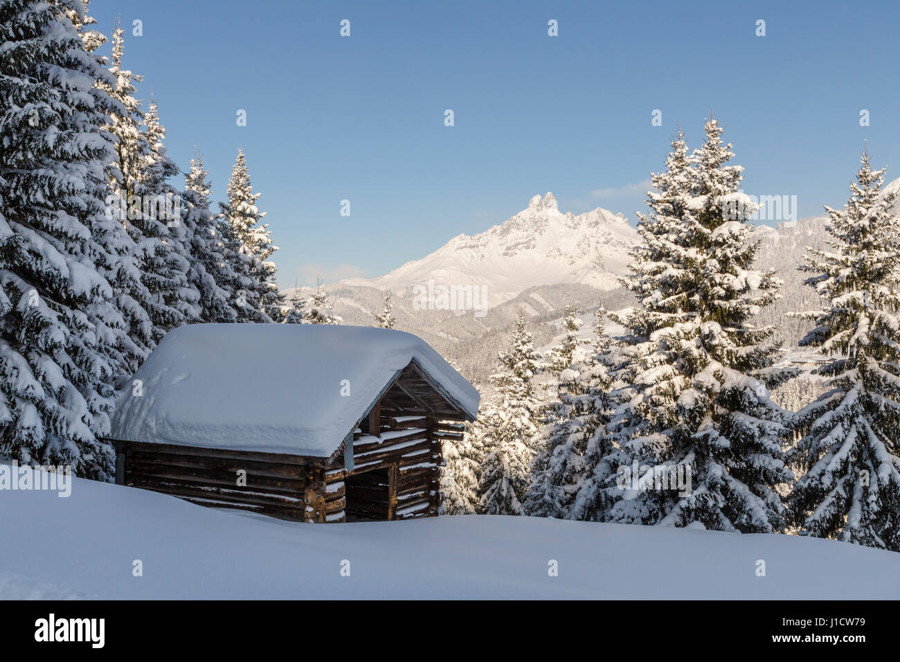 Log cabin in a snow covered landscape in the Austrian Alps Stock Photo ...