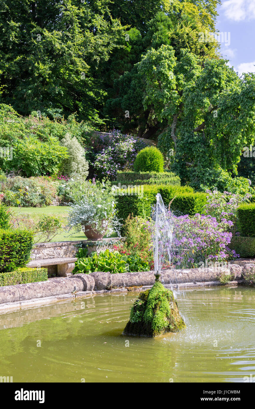 The fountain and herbaceous borders in the sunken Italianate garden ...