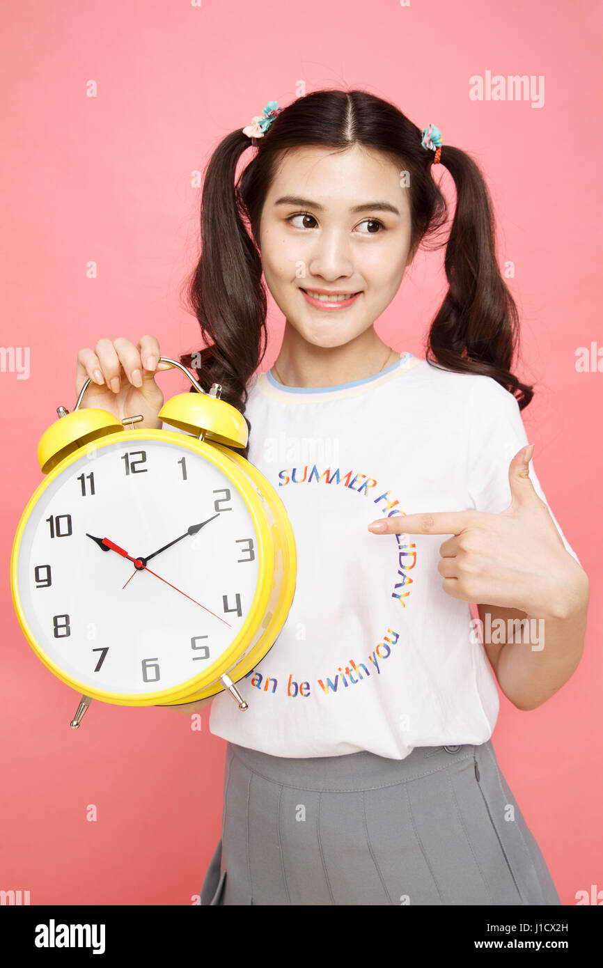 A young girl with a clock Stock Photo - Alamy