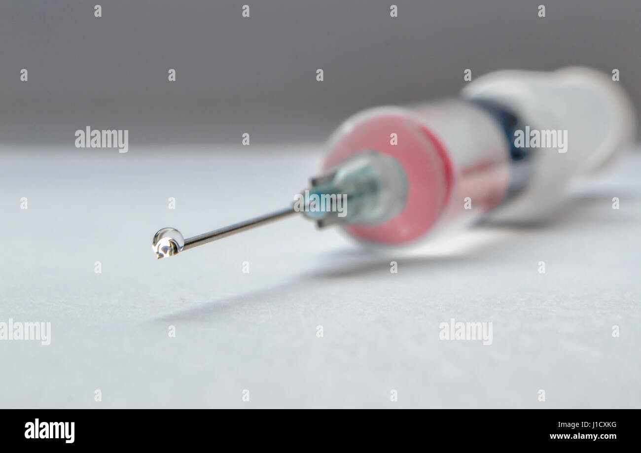 Drop on syringe needle Stock Photo - Alamy