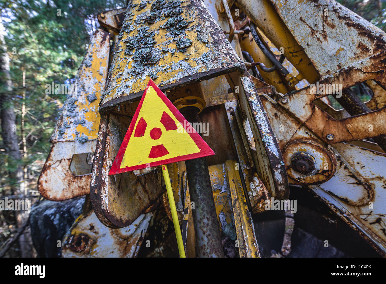 Warning sign in front of irradiated scrap bucket in Pripyat city of ...