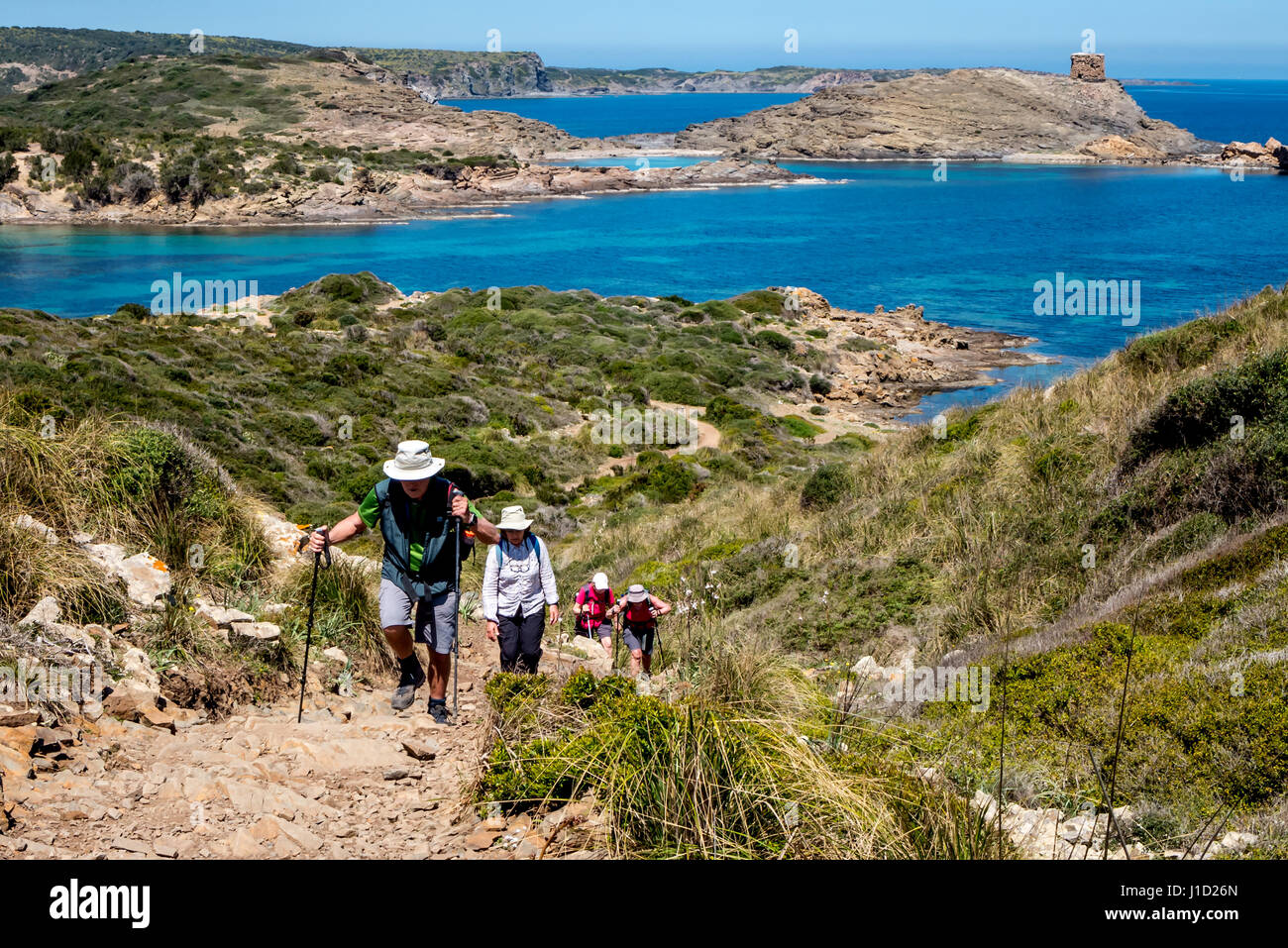 Walkers on the Cami de Cavalls coastal path in Menorca Stock Photo - Alamy