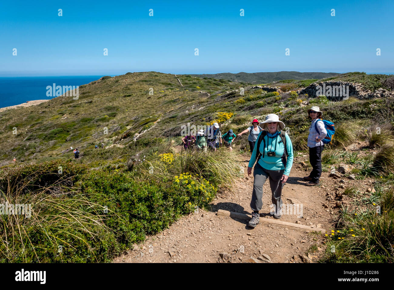 Walkers on the Cami de Cavalls coastal path in Menorca Stock Photo - Alamy