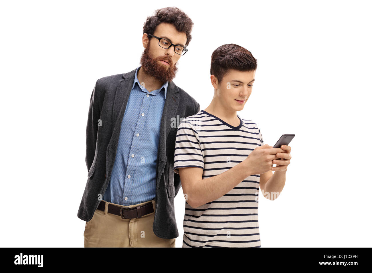 Concerned father peeking at the phone of his son isolated on white ...