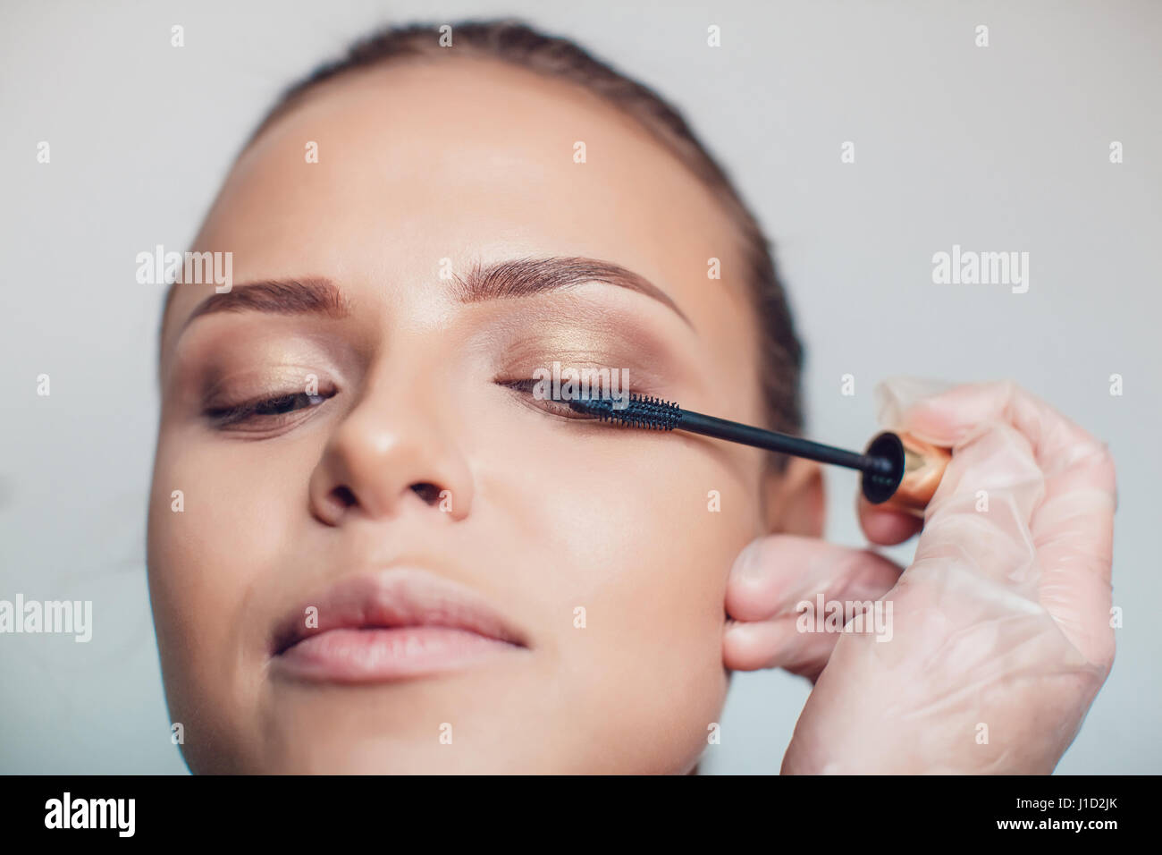 Professional make-up artist makes eye makeup of model. Beauty and ...