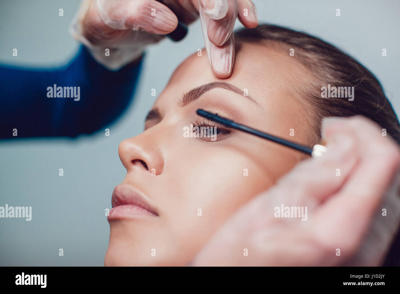 Professional make-up artist makes eye makeup of model. Beauty and ...