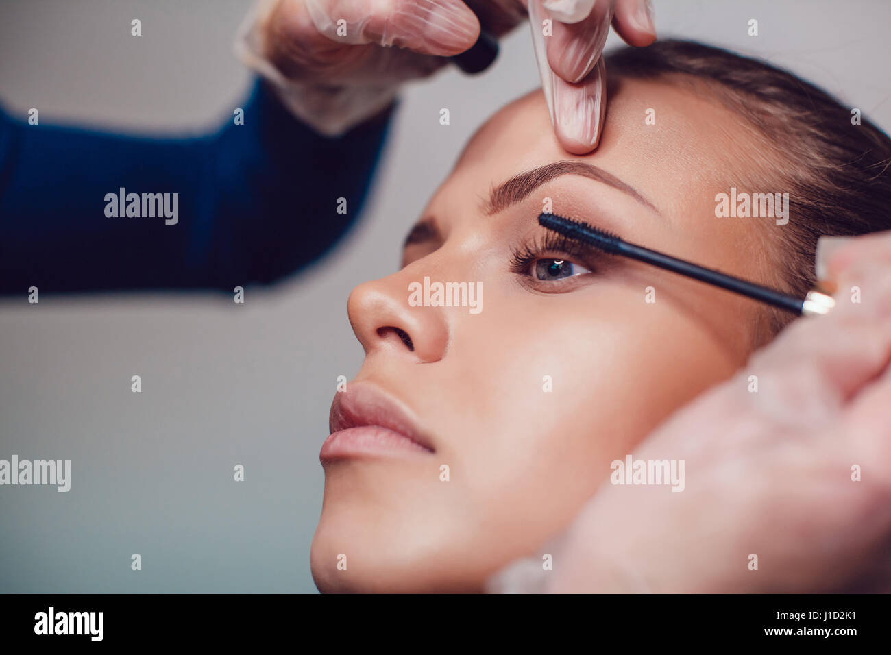 Professional make-up artist makes eye makeup of model. Beauty and ...