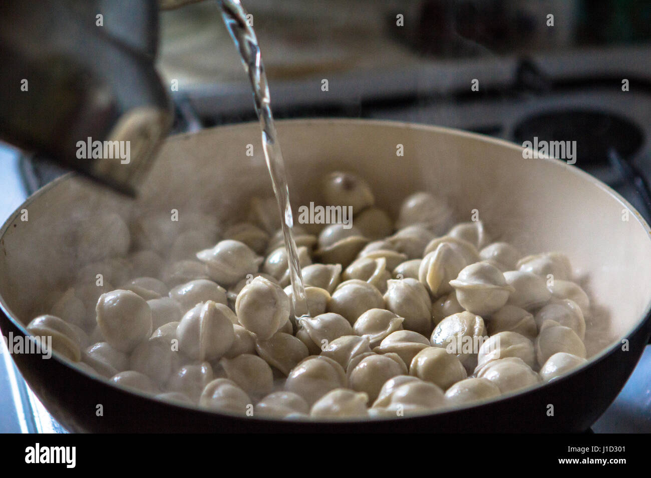 Fresh meat dumplings - cooking russian boiled pelmeni Stock Photo - Alamy