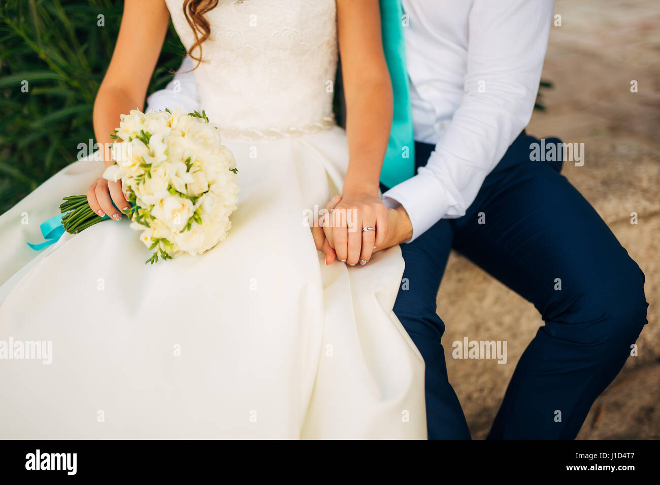 Bride and groom holding hands Stock Photo - Alamy