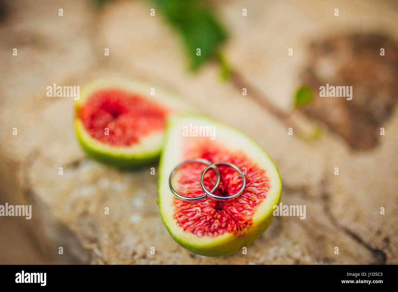 Wedding rings on figs Stock Photo - Alamy