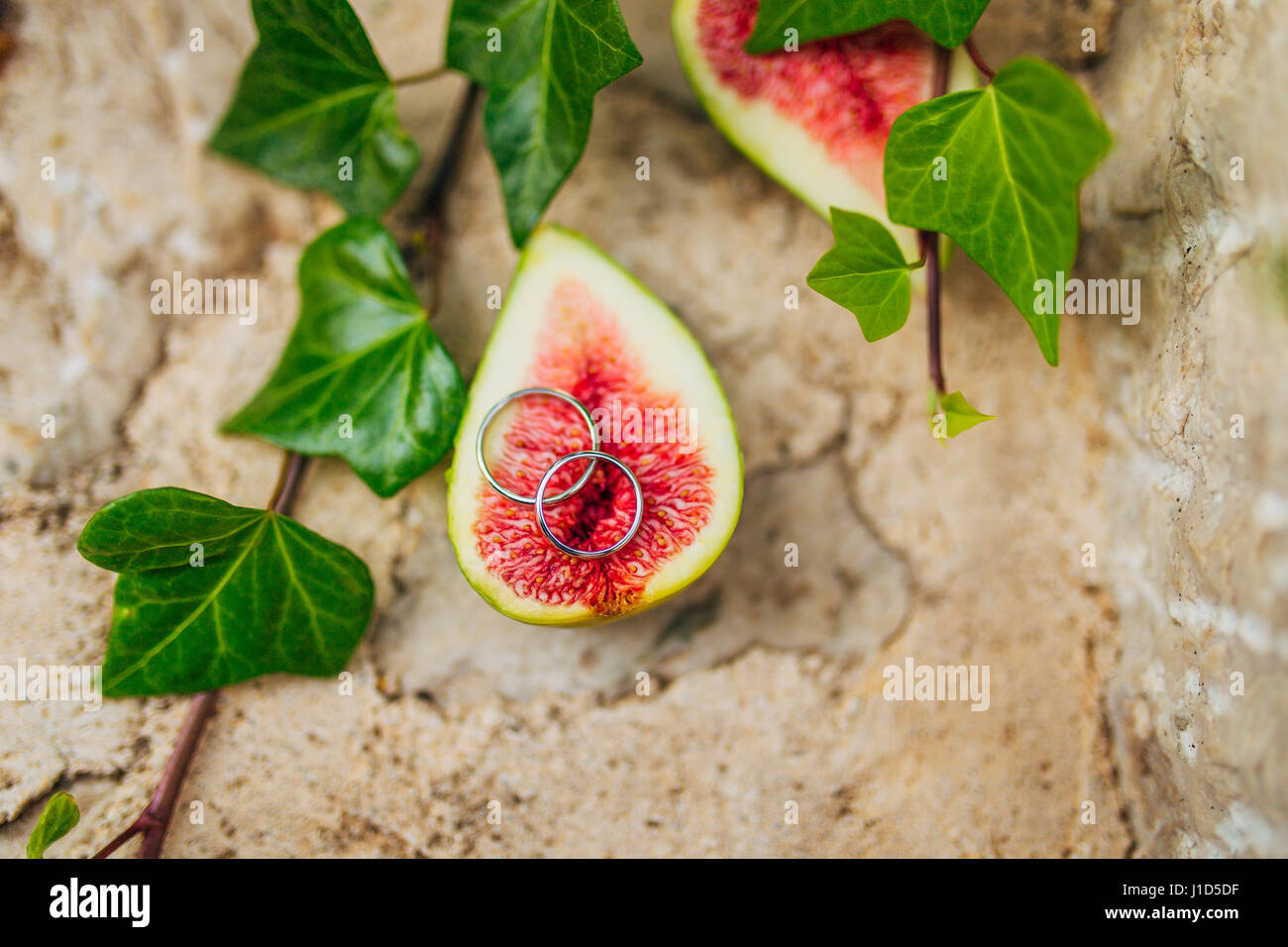 Wedding rings on figs Stock Photo - Alamy