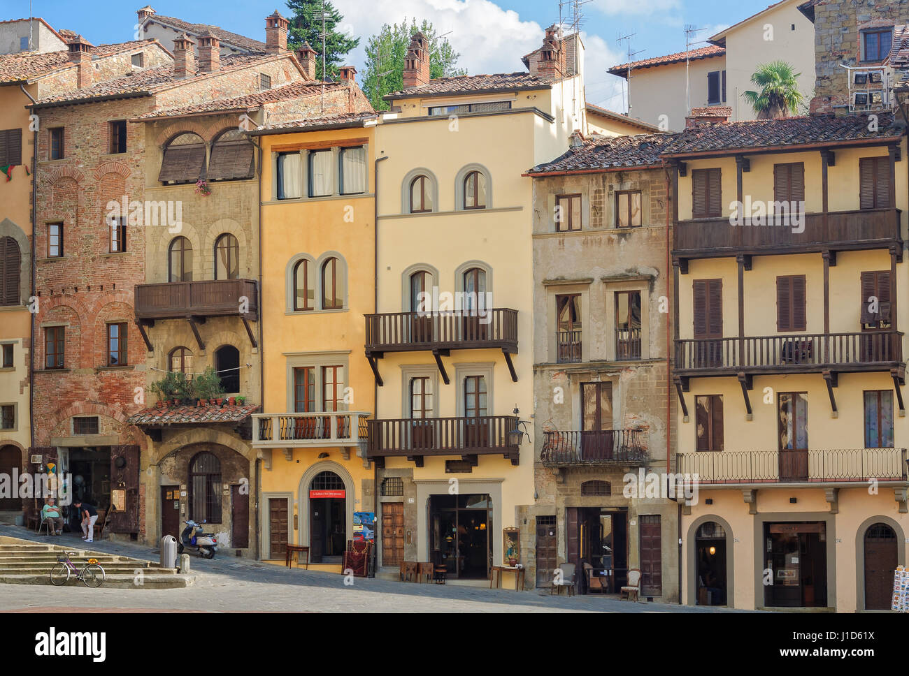 Narrow four storey buildings on the East corner of the sloping Piazza ...