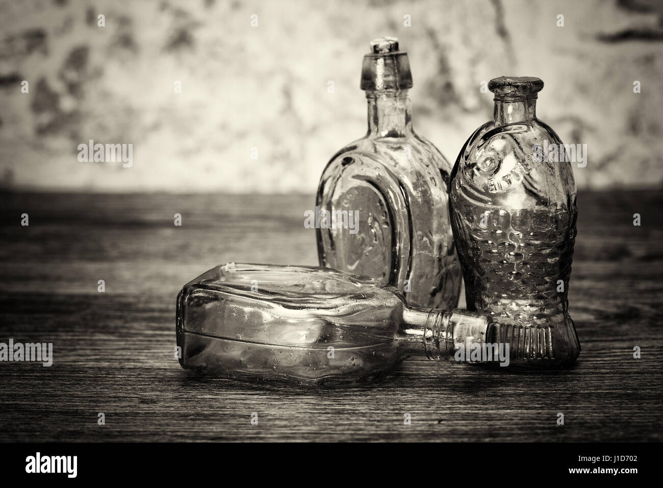 Selection of coloured glass bottles on a rustic background Stock Photo ...