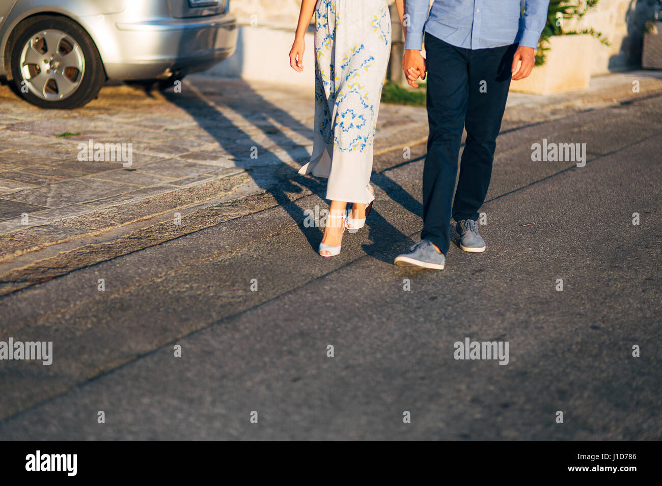 Female and male feet on the pavement Stock Photo - Alamy