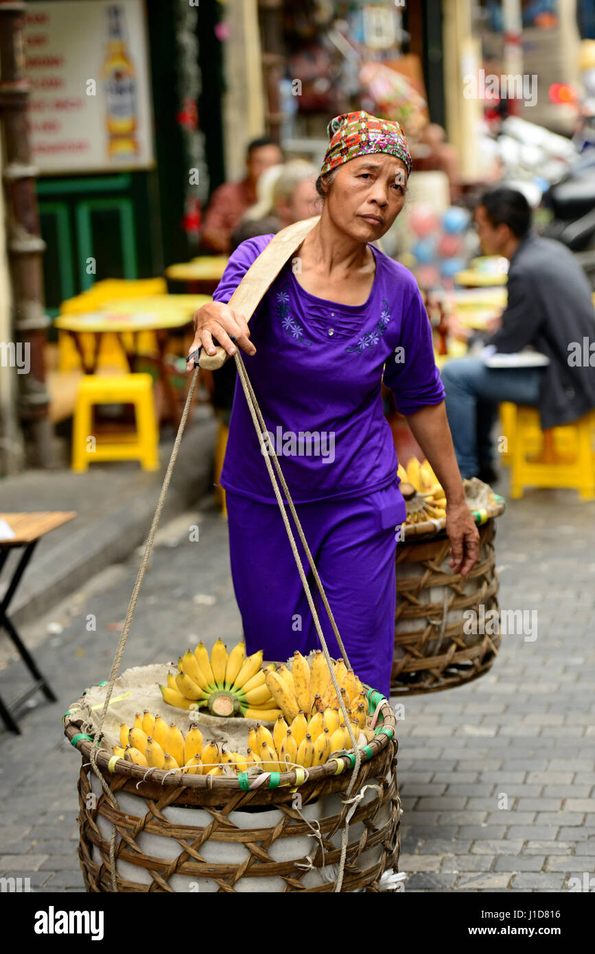 Street traders and hawkers selling hats, fruit, vegetables, cleaning ...