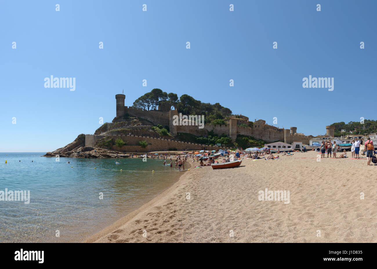 Holidayer people are on Platja Gran beach with fortress ‘’Vila Vella ...