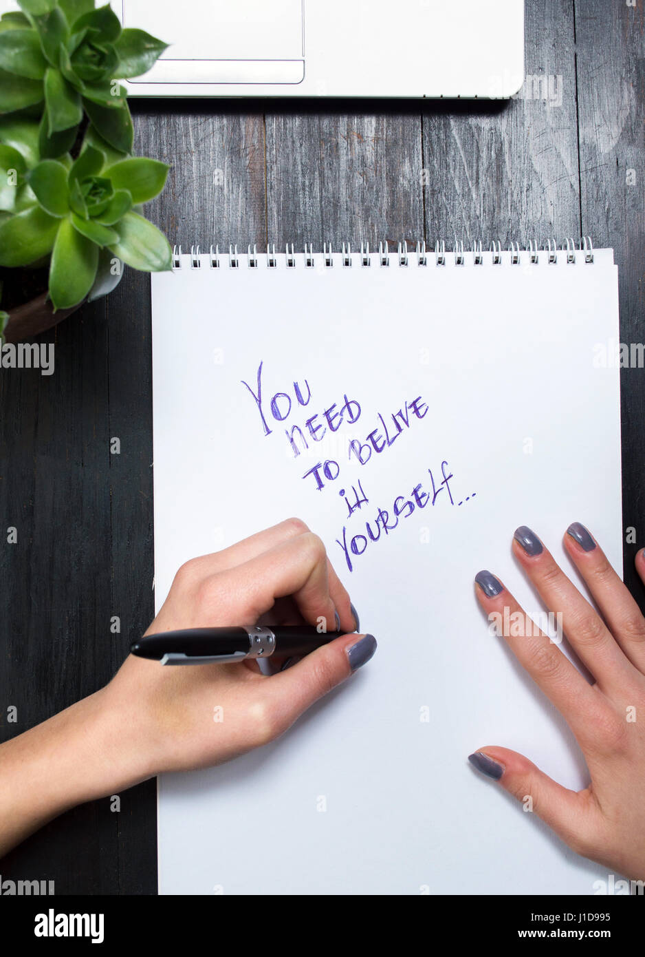 Female hands writing motivational message in a notebook Stock Photo - Alamy