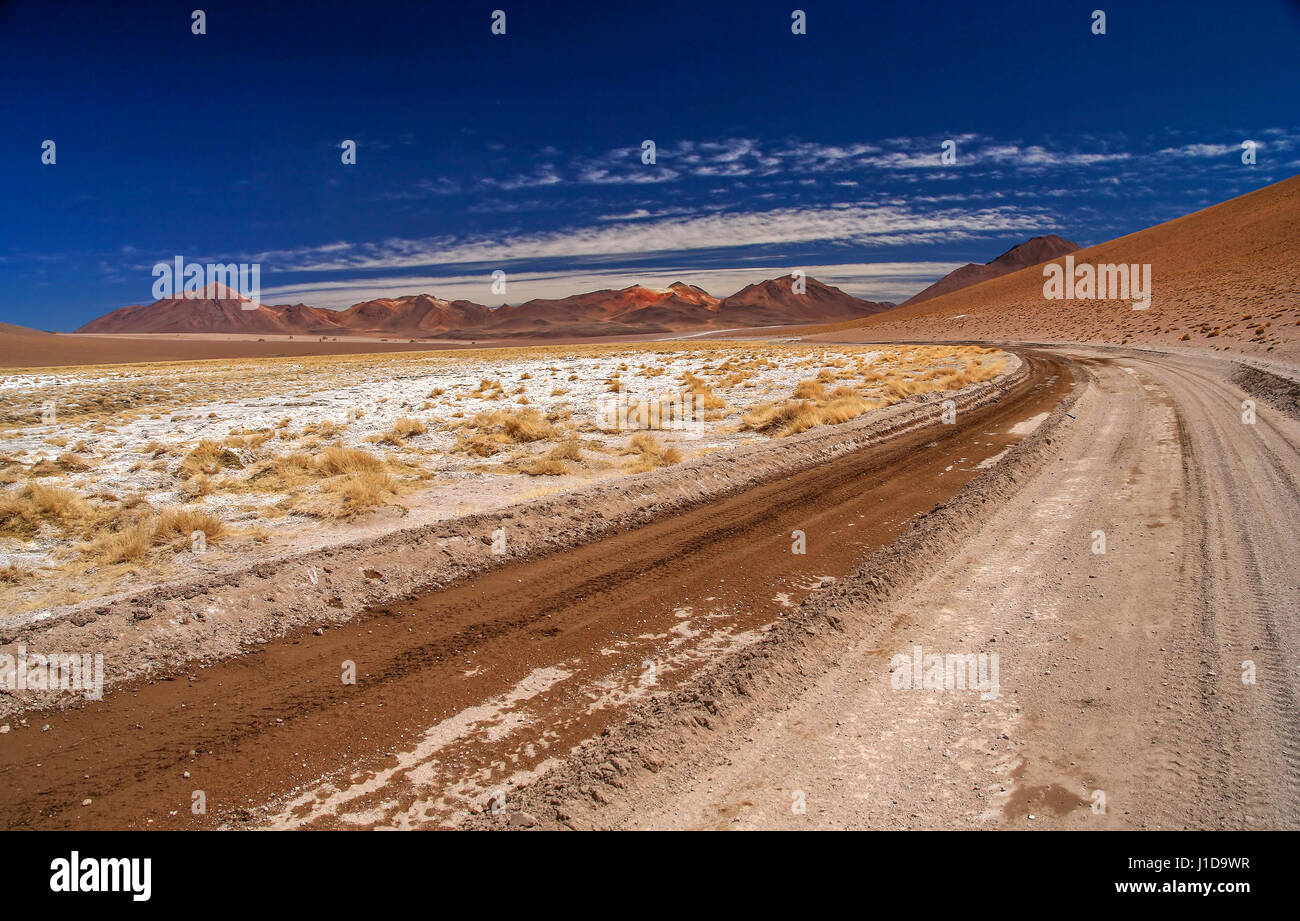 Muddy and sandy gravel desert road through remote part of southern ...