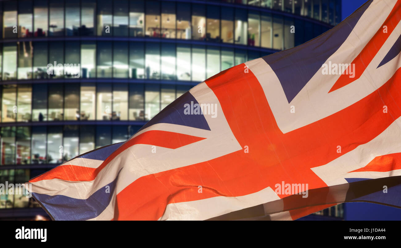 union jack flag over London financial district with iconic skyscrapers ...