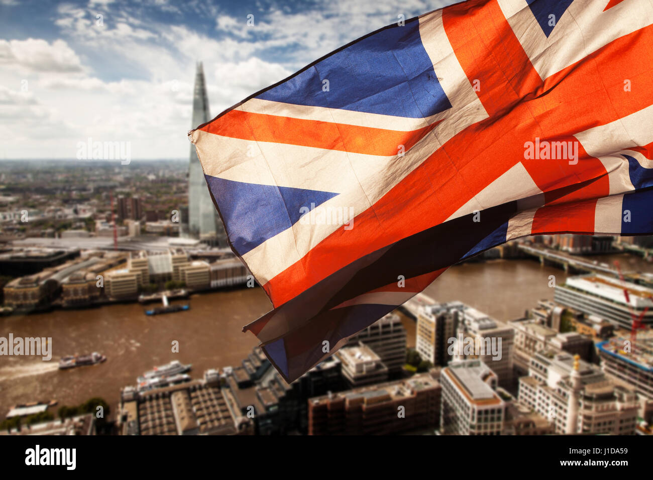union jack flag over London financial district with iconic skyscrapers ...