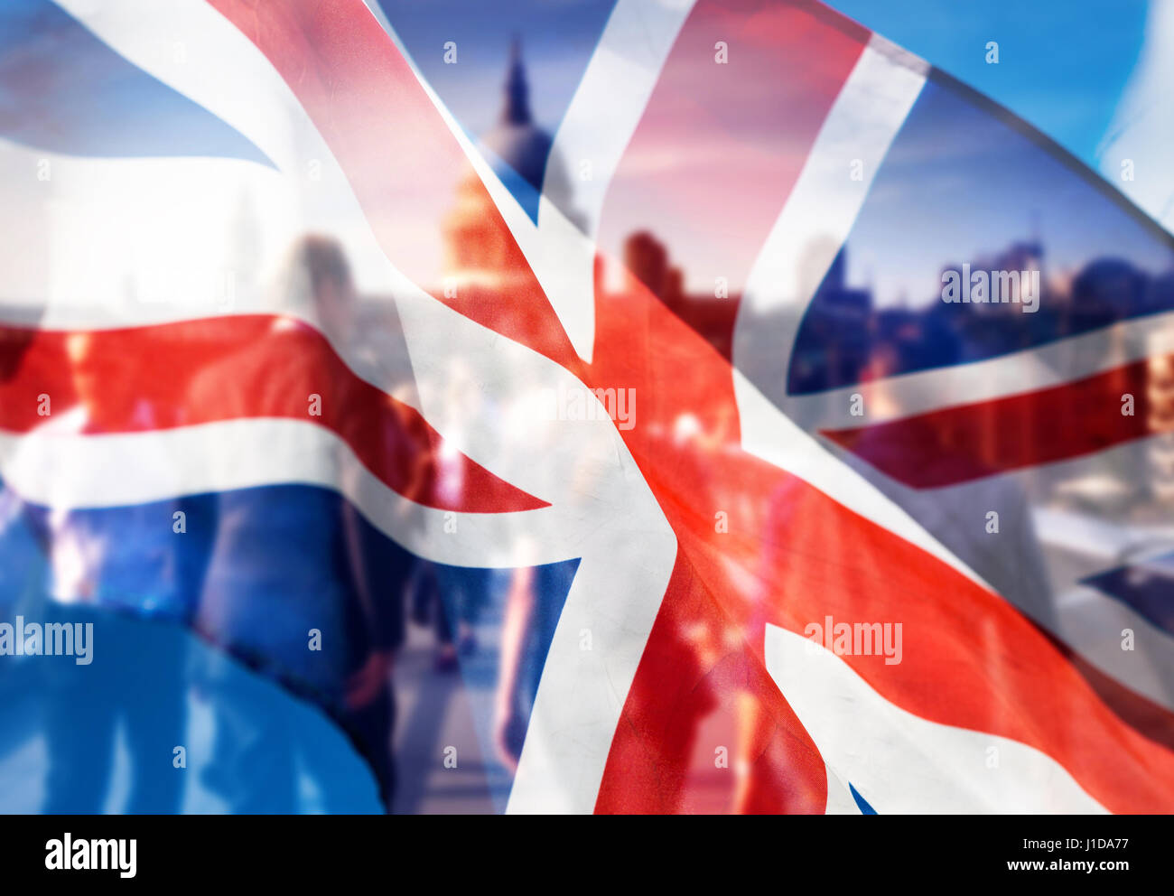 union jack flag and people walking on Millenium bridge in the ...