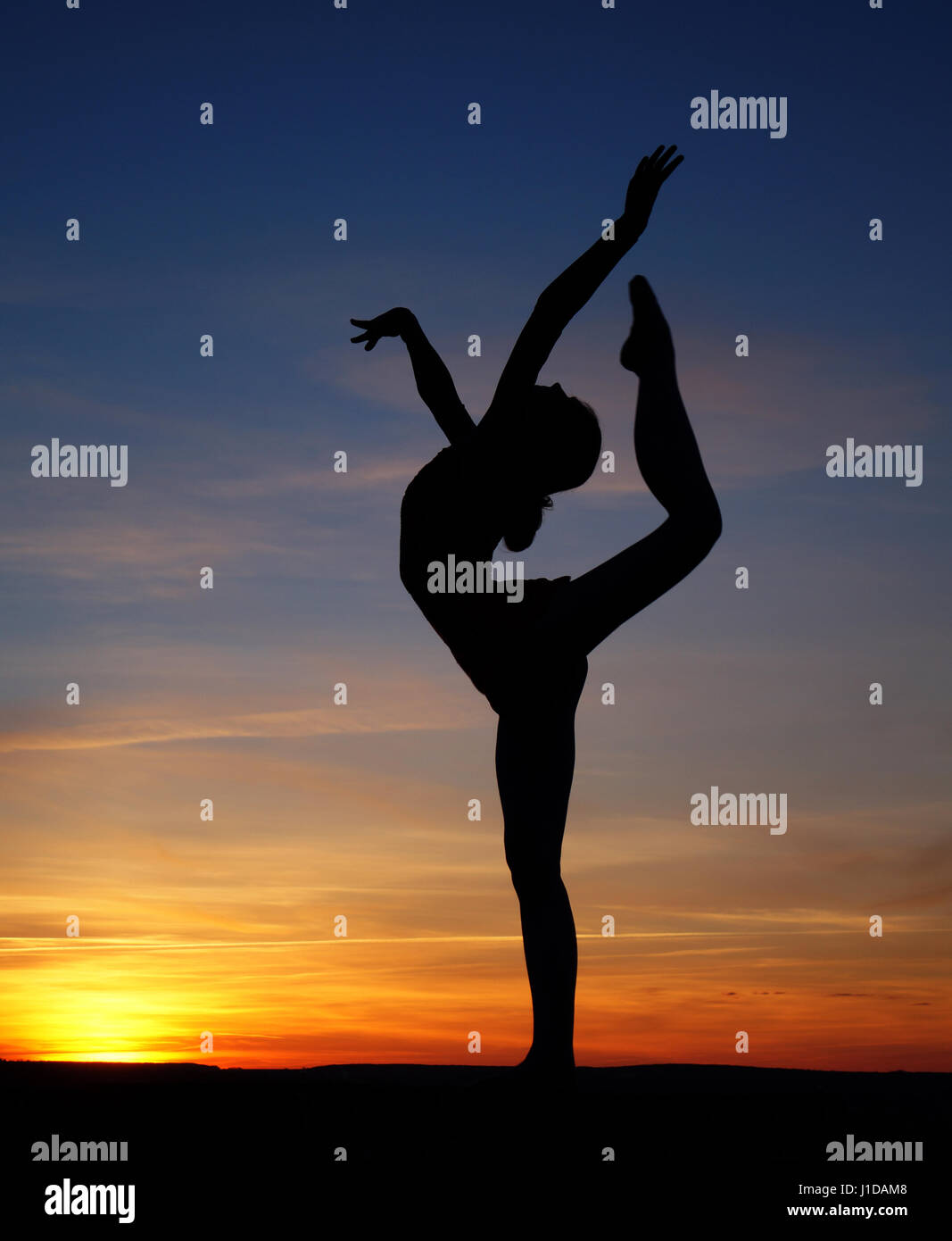 dancer in the dance does the splits in the air against the sunset Stock ...