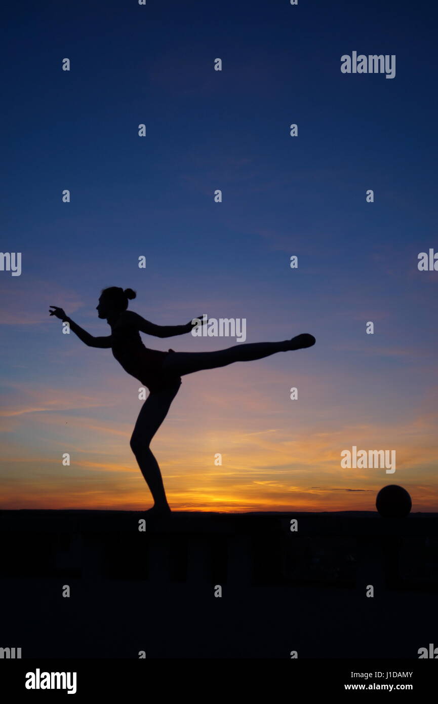 dancer in the dance does the splits in the air against the sunset Stock ...