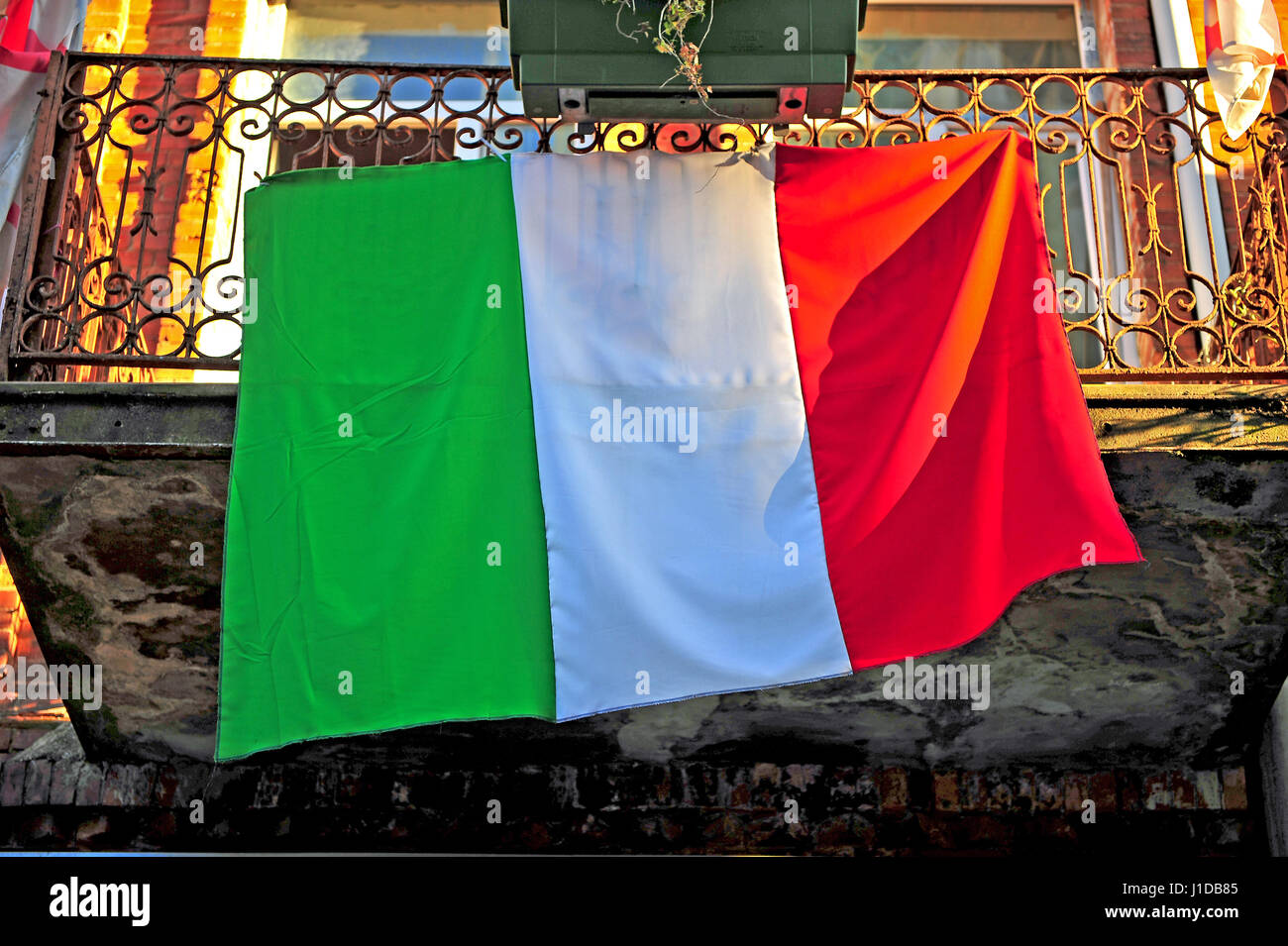 House balcony with a huge italian flag Stock Photo - Alamy