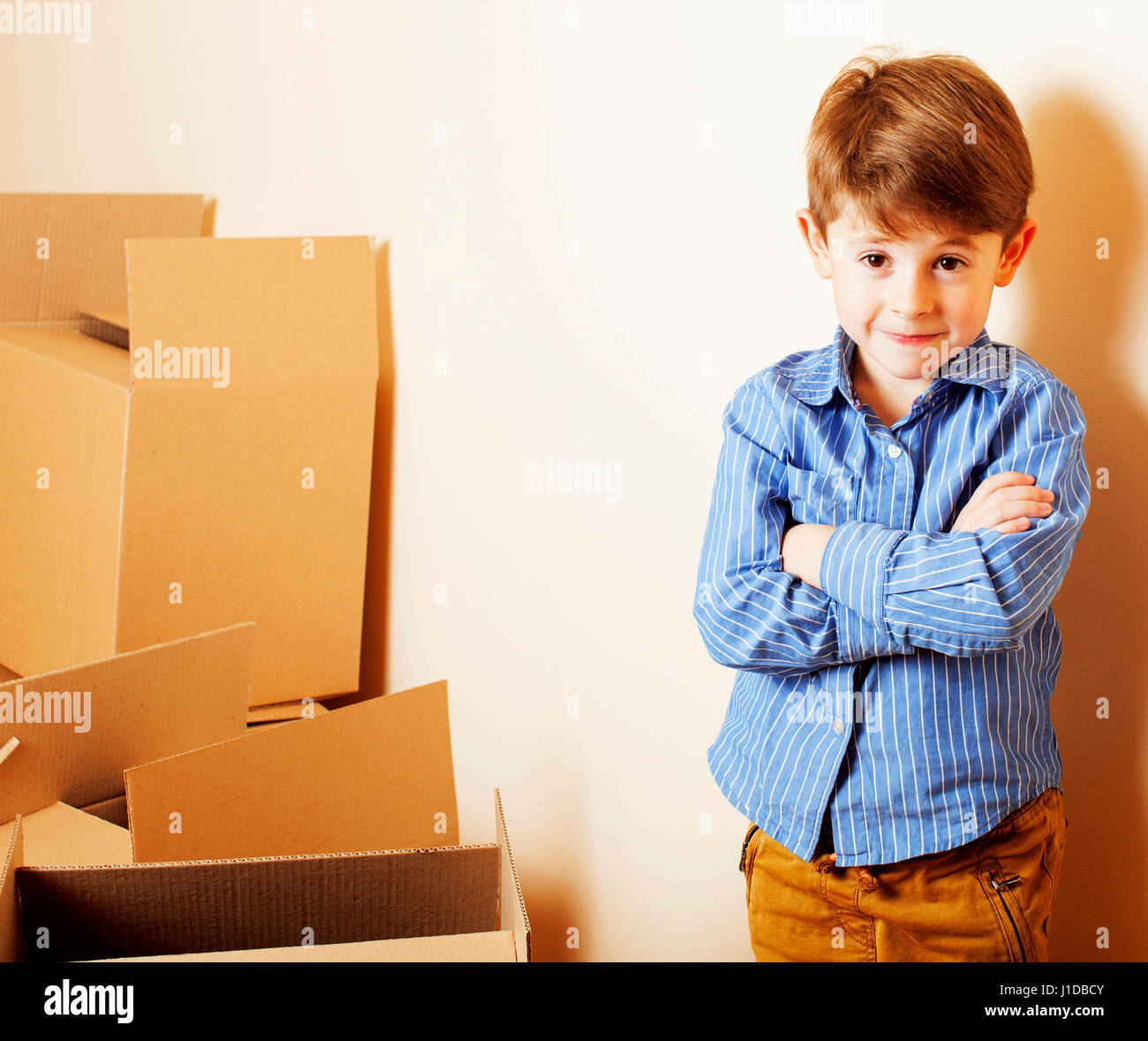 little cute boy in empty room, remoove to new house. home alone Stock ...
