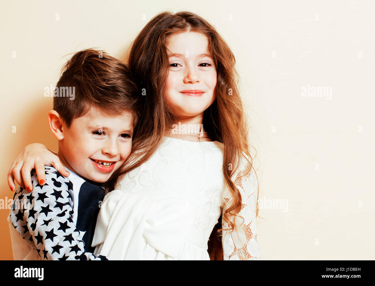 little cute boy and girl hugging playing on white background, ha Stock Photo - Alamy