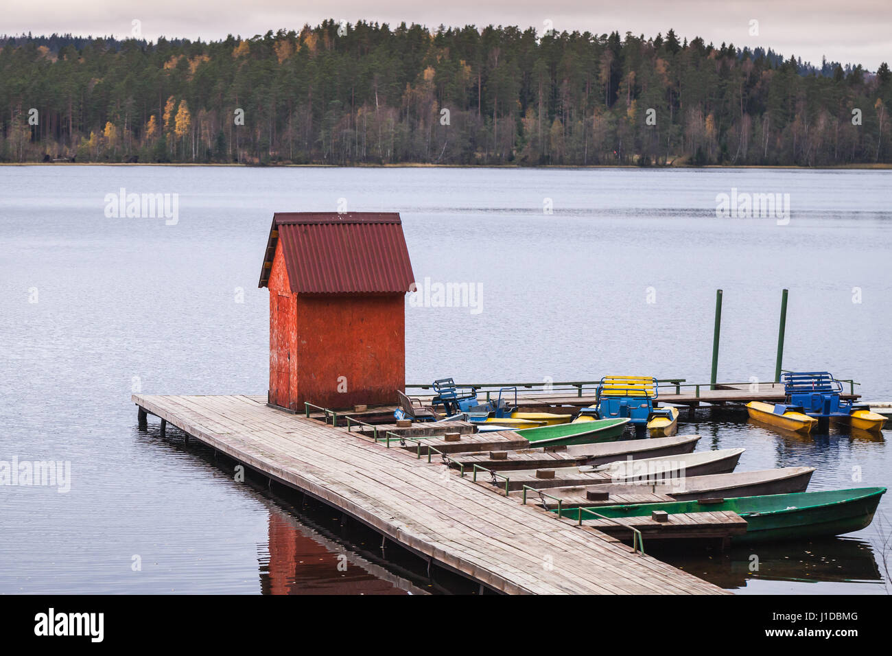 Small red barn on floating pier with moored row boats, Karelia, Russia ...