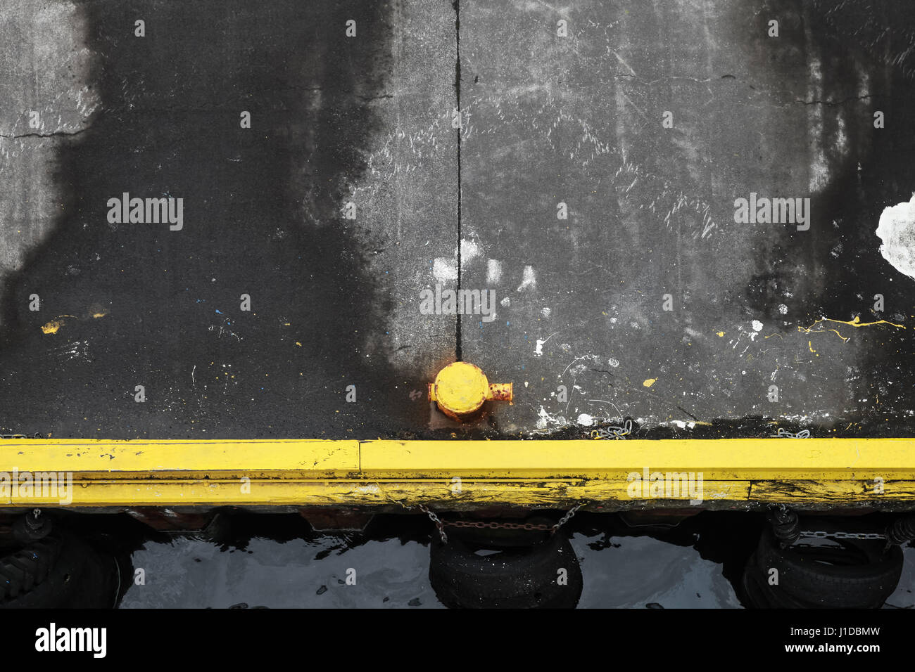 Ships mooring equipment, yellow port bollard on concrete pier, top view ...
