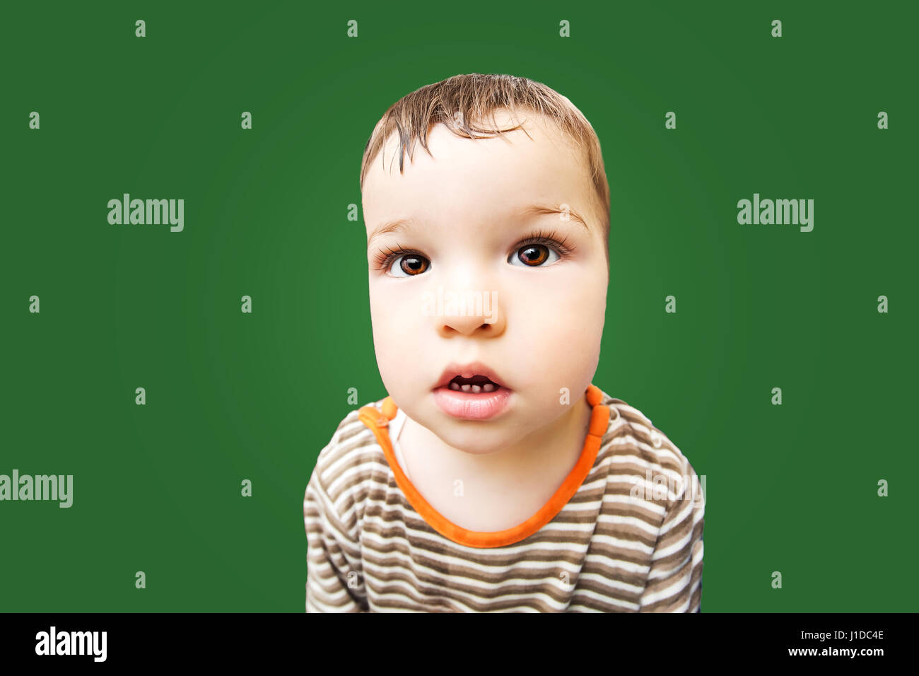 close-up portrait of little cute child with big cheeks and beautiful ...