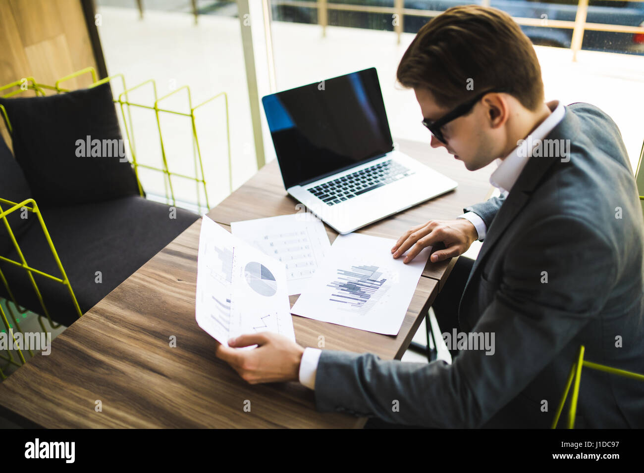 Young employee looking at computer monitor during working day in office ...